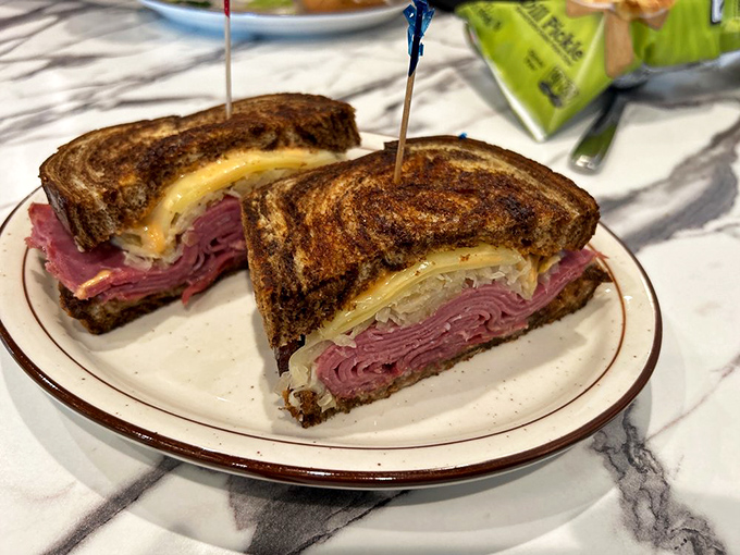 The Reuben in its natural habitat – perfectly grilled marble rye housing a harmonious marriage of corned beef, sauerkraut, and Swiss that would make New York proud.