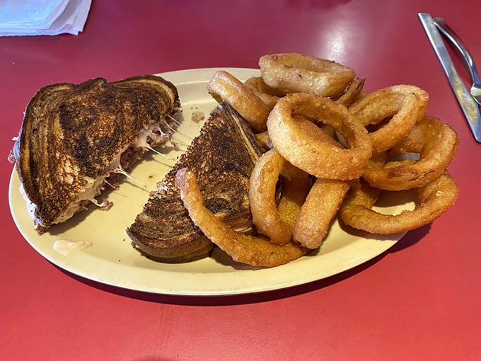 That perfect Reuben moment: when the grilled rye shatters slightly, the cheese stretches, and those golden onion rings stand at attention, ready for their supporting role.