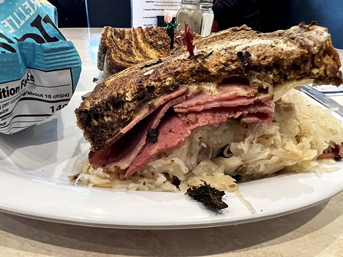 Behold the Reuben in its natural habitat—a mountain of corned beef and sauerkraut that makes you wonder if your jaw can unhinge like a snake.