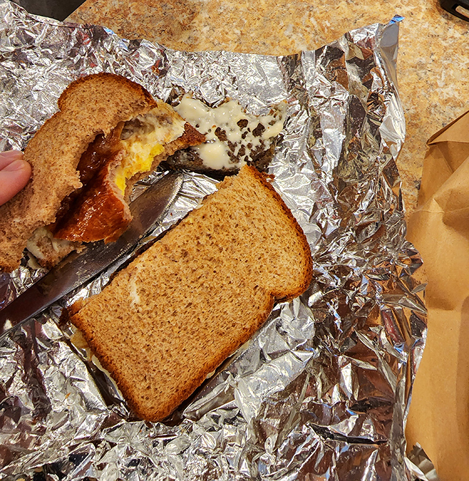 Breakfast sandwich architecture at its finest—melty cheese cascading over scrapple between perfectly toasted bread. The morning masterpiece Michelangelo never painted.