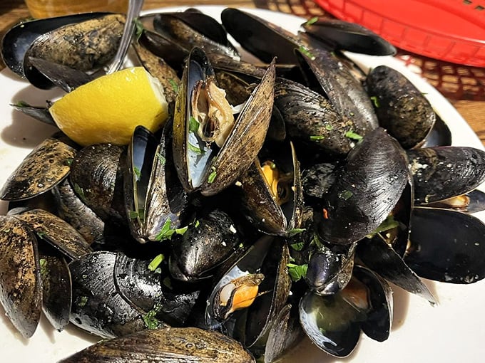 These glistening mussels aren't just dinner—they're an oceanic symphony, each shell opening to reveal a briny treasure enhanced by fresh herbs and lemon.