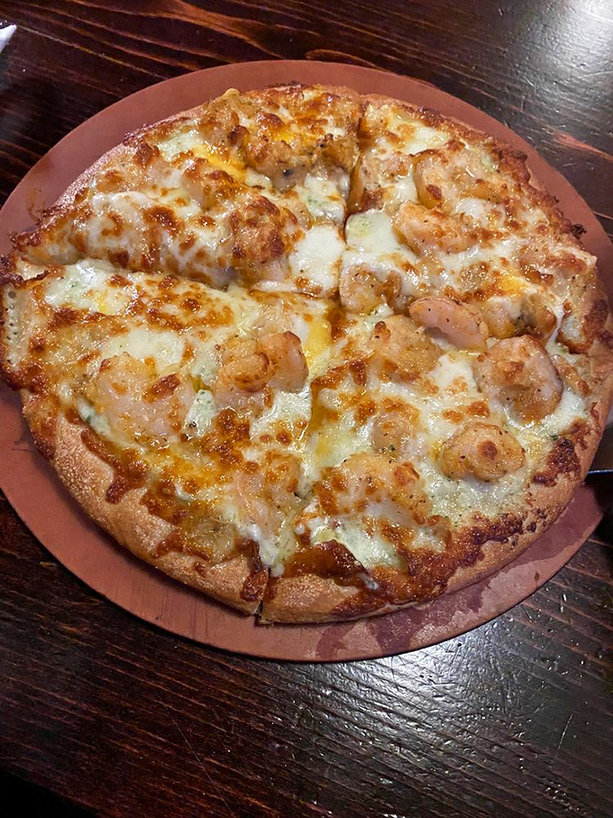 This seafood pizza isn't just food; it's a maritime celebration. Those plump shrimp nestled in melted cheese make me want to high-five the chef. 