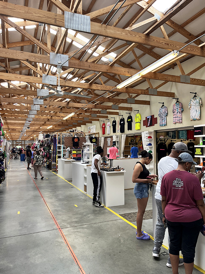 Shoppers browse clothing displays under the market's signature exposed beam ceiling. Every rack holds potential for that perfect "where did you find that?" piece.