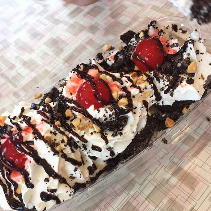 This isn't just a sundae—it's an architectural masterpiece of whipped cream, hot fudge, and cherries that would make Frank Lloyd Wright put down his blueprints and pick up a spoon.