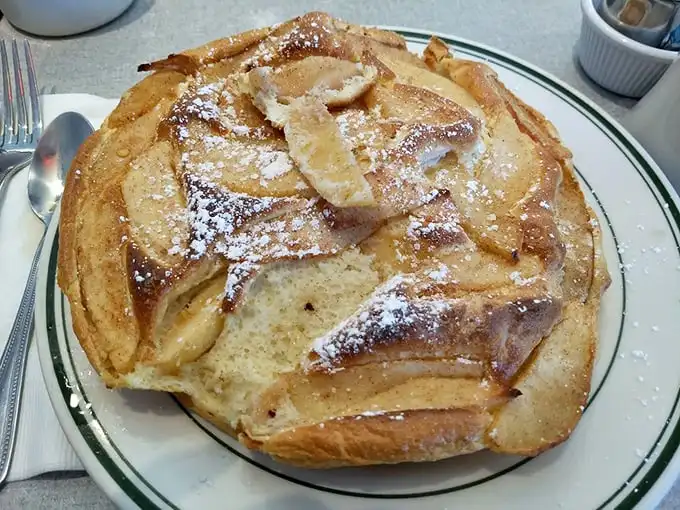 Not all heroes wear capes; some come as souffle pancakes dusted with powdered sugar and topped with caramelized apples. Fork required, restraint optional.