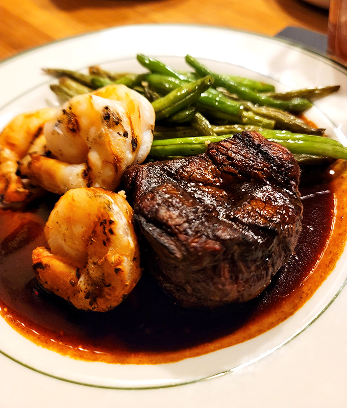 Surf meets turf perfection: a masterfully seared filet mignon shares the spotlight with plump shrimp and crisp asparagus.