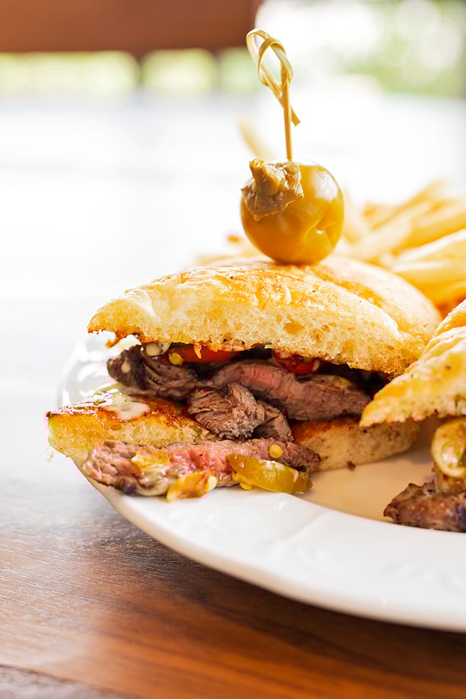 The legendary steak sandwich in all its glory—tender meat, sweet peppers, and béarnaise sauce creating a holy trinity of flavor worth crossing state lines for.