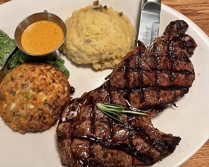 This isn't just dinner—it's a trilogy of deliciousness featuring a juicy steak, creamy mashed potatoes, and a crab cake that deserves its own fan club.