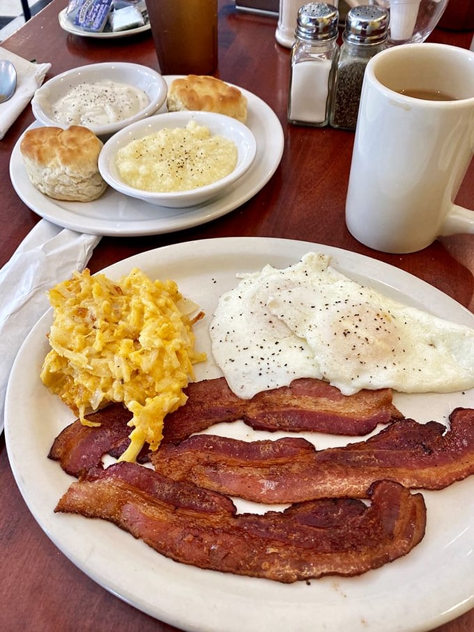 Breakfast nirvana achieved: perfectly cooked eggs, bacon with that ideal crisp-to-chewy ratio, and biscuits that would make your grandmother jealous.