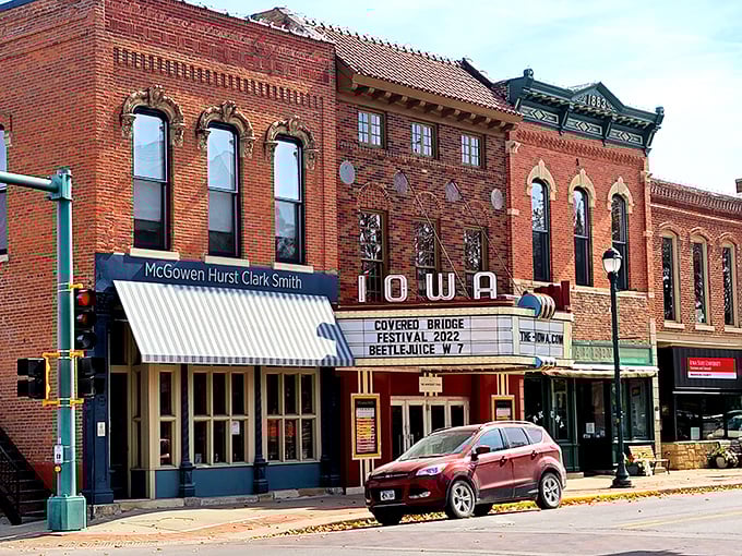 The Iowa Theater's vintage marquee promises entertainment the old-fashioned way—no algorithms suggesting what to watch, just community consensus on what's worth seeing.
