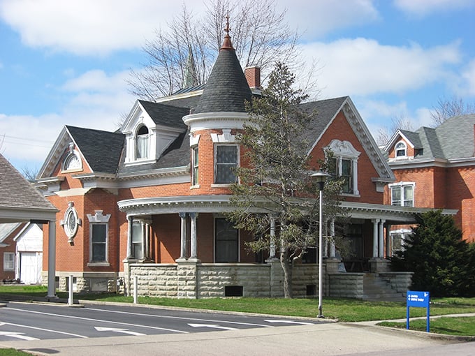 This Queen Anne Victorian beauty could make HGTV hosts weep with joy. Red brick, ornate trim, and that tower—because everyone needs a proper spot for contemplating life's mysteries.