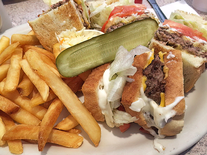 This isn't just a sandwich—it's architecture. Layers of flavor stacked between toast with a pickle sentinel standing guard. The fries aren't an afterthought; they're co-stars.