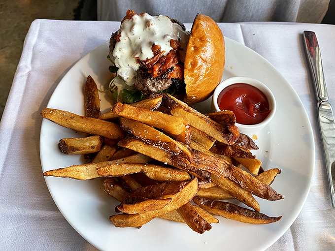 Golden fries that crackle with each bite, paired with a burger that's wearing cheese like a cozy winter sweater.