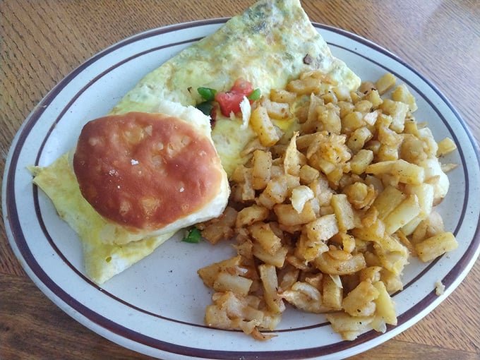 The veggie omelet arrives like edible sunshine, with those legendary hash browns stealing the spotlight. A perfect marriage of healthy and indulgent.