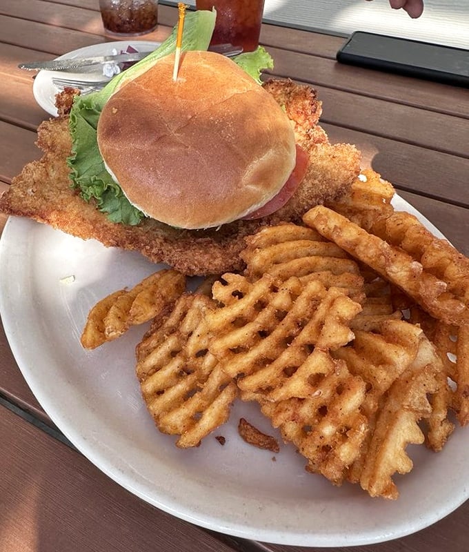 Those waffle fries aren't just side dishes—they're supporting actors who keep stealing the scene from that magnificent pork tenderloin sandwich.