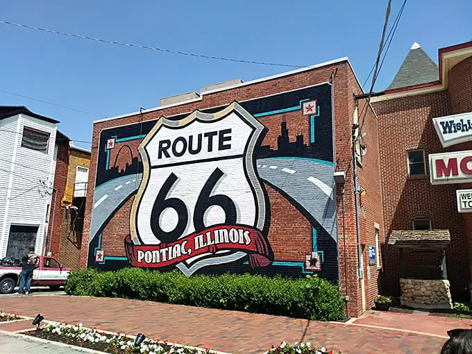 Nothing says "you've arrived somewhere special" like a giant Route 66 shield mural welcoming travelers to a town that embraces its place in American road trip lore.
