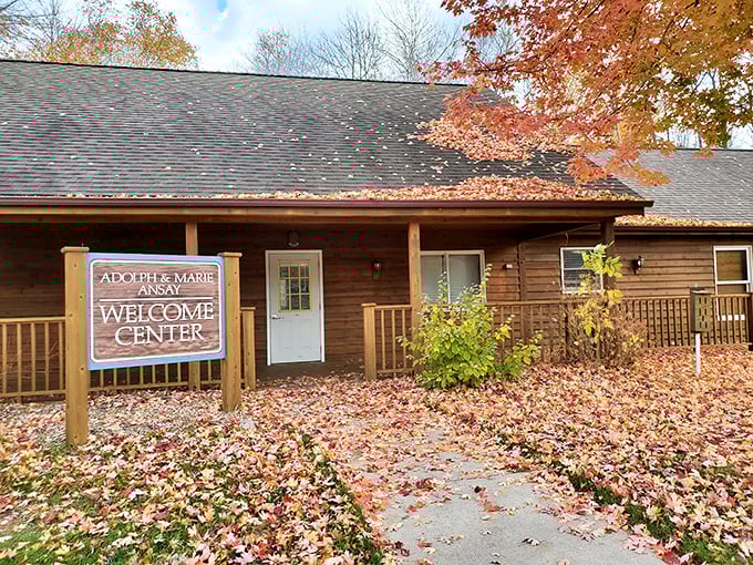 Autumn transforms the Welcome Center into a scene worthy of a calendar cover. Those fallen leaves aren't making a mess—they're creating nature's red carpet.