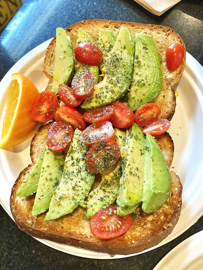 Avocado toast that actually deserves its Instagram fame. Those vibrant cherry tomatoes and perfectly fanned avocado slices make "eating your greens" feel downright indulgent.