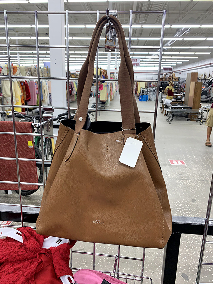 Designer dreams at thrift store prices! This leather tote bag with its pristine tag is the kind of find that makes dedicated thrifters do a little victory dance in the aisle.