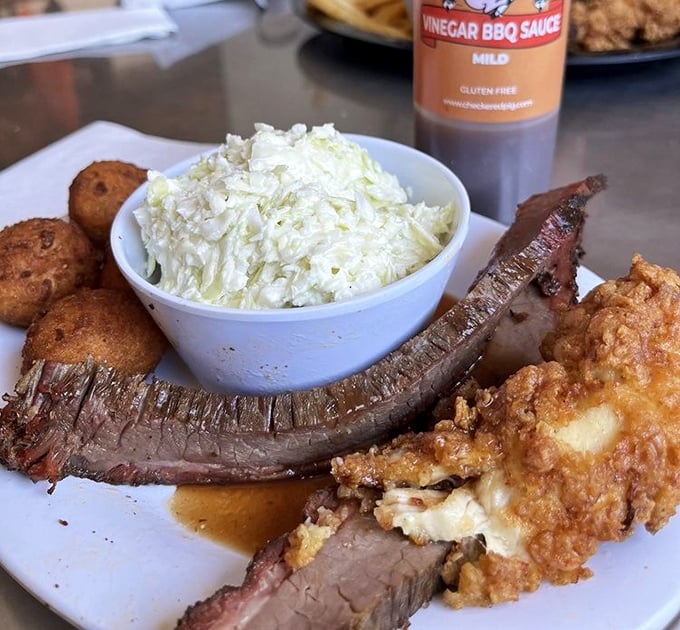 Behold the holy trinity of Southern comfort: tender brisket with that perfect smoke ring, golden hushpuppies, and coleslaw that cuts through the richness like a cool breeze.