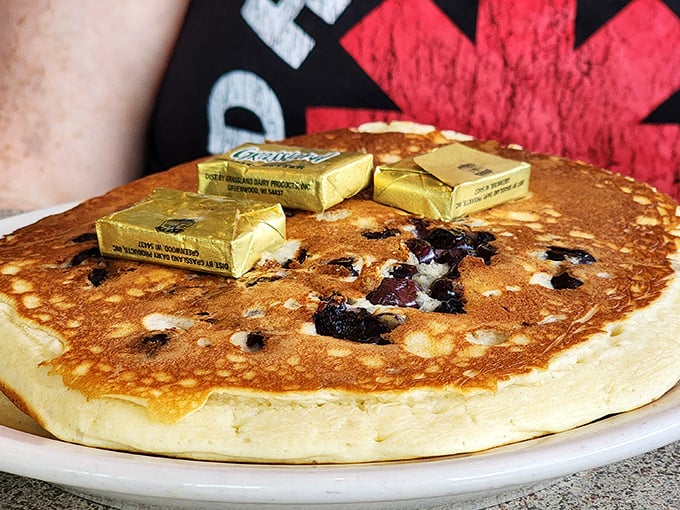 Blueberry pancakes topped with butter squares like golden thrones—the breakfast equivalent of winning the lottery without having to share it with relatives.