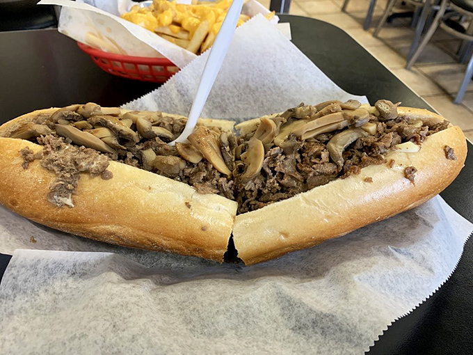 Behold the star of the show! Thinly chopped steak and mushrooms spill from a perfectly golden roll – this isn't a meal, it's an event.