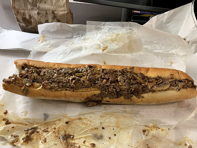 Behold the cheesesteak in its natural habitat – a perfect ratio of meat to bread, where every bite delivers that flavor symphony Philadelphia made famous.