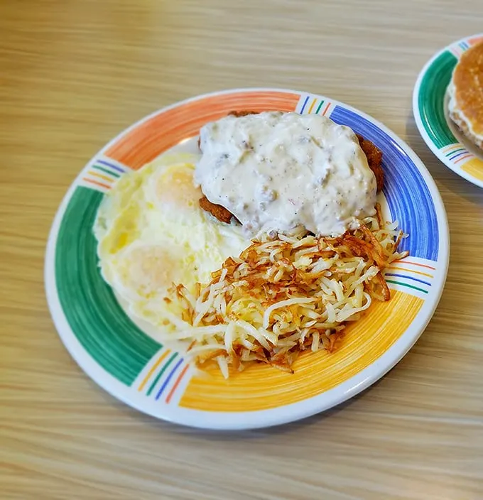 Behold, the star of our show—chicken fried steak swimming in gravy with eggs and hash browns standing by, ready for their supporting roles.