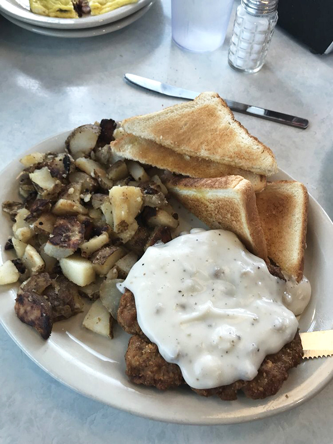 This isn't just chicken fried steak—it's edible nostalgia, smothered in pepper gravy that could make your grandmother both jealous and proud at the same time.