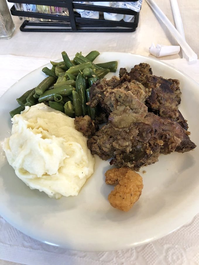 Comfort food doesn't always wear a fancy outfit. These chicken livers, mashed potatoes, and green beans represent the holy trinity of heartland dining.