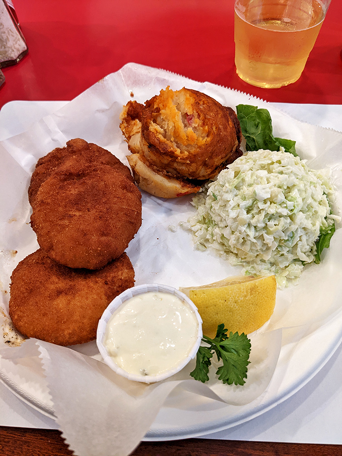 Golden crab cakes paired with crisp coleslaw – comfort food that makes your taste buds do a happy dance.