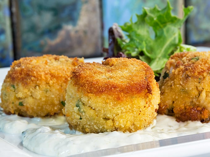 These golden crab cakes aren't just appetizers—they're an opening act that threatens to upstage the headliner. Crispy exterior, heavenly inside.
