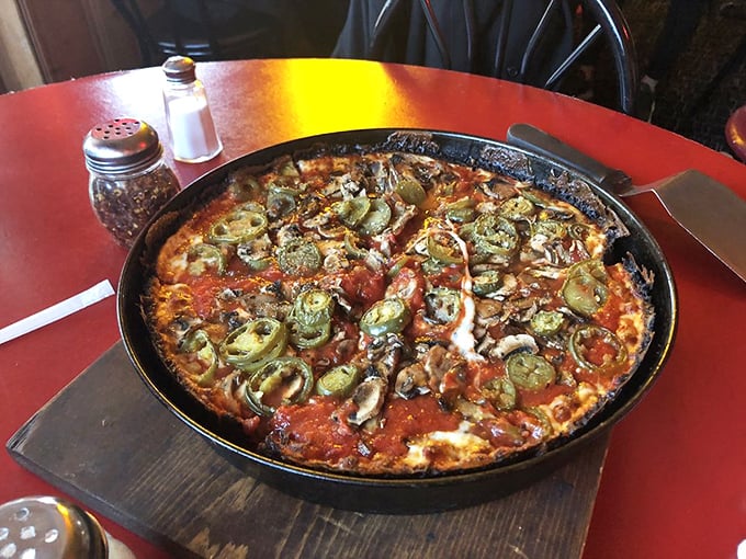 Pizza architecture at its finest—layers of toppings, chunky sauce, and that signature blackened cheese perimeter that's worth crossing state lines to experience.