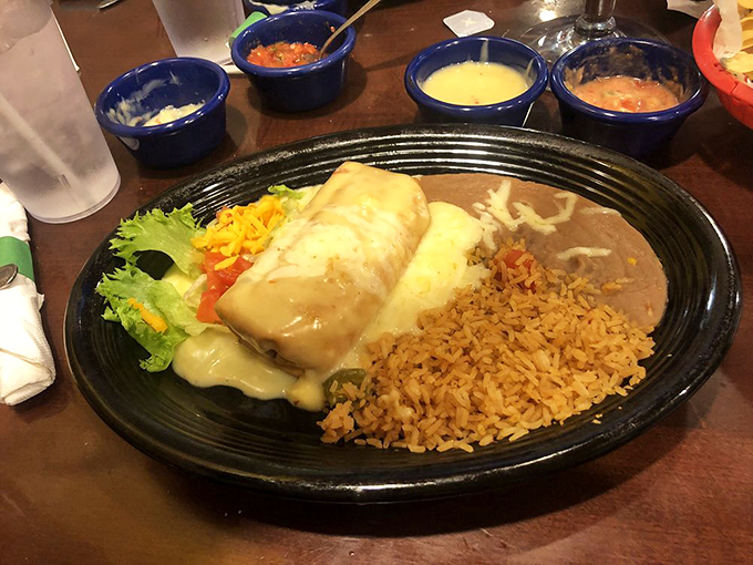 This isn't just a burrito—it's a work of art. Smothered in creamy sauce and nestled beside perfectly seasoned rice and beans, it's comfort food that speaks fluent Spanish.