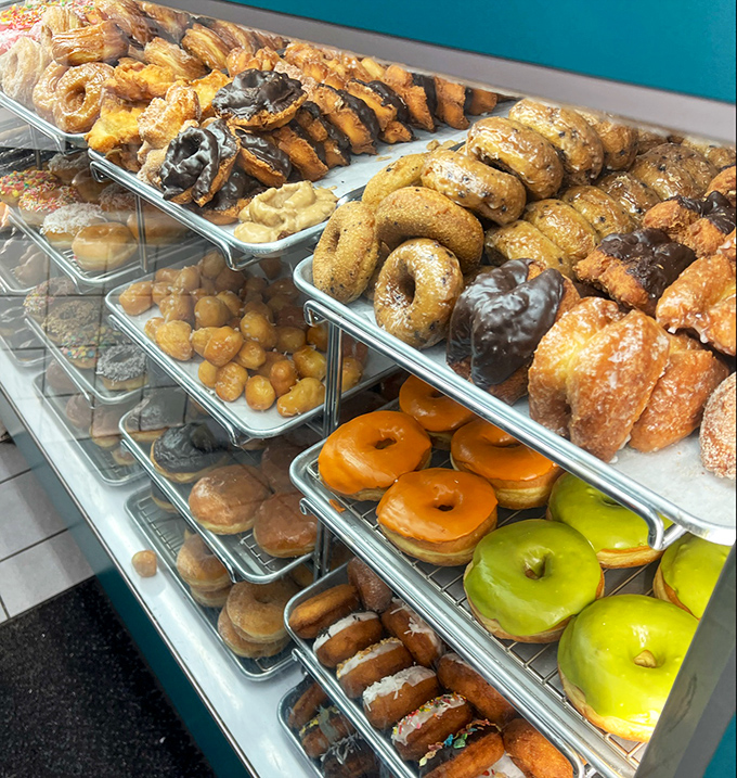 Donut heaven exists, and it looks exactly like this—rows of golden, glazed, chocolate-dipped treasures waiting patiently for their moment of glory.