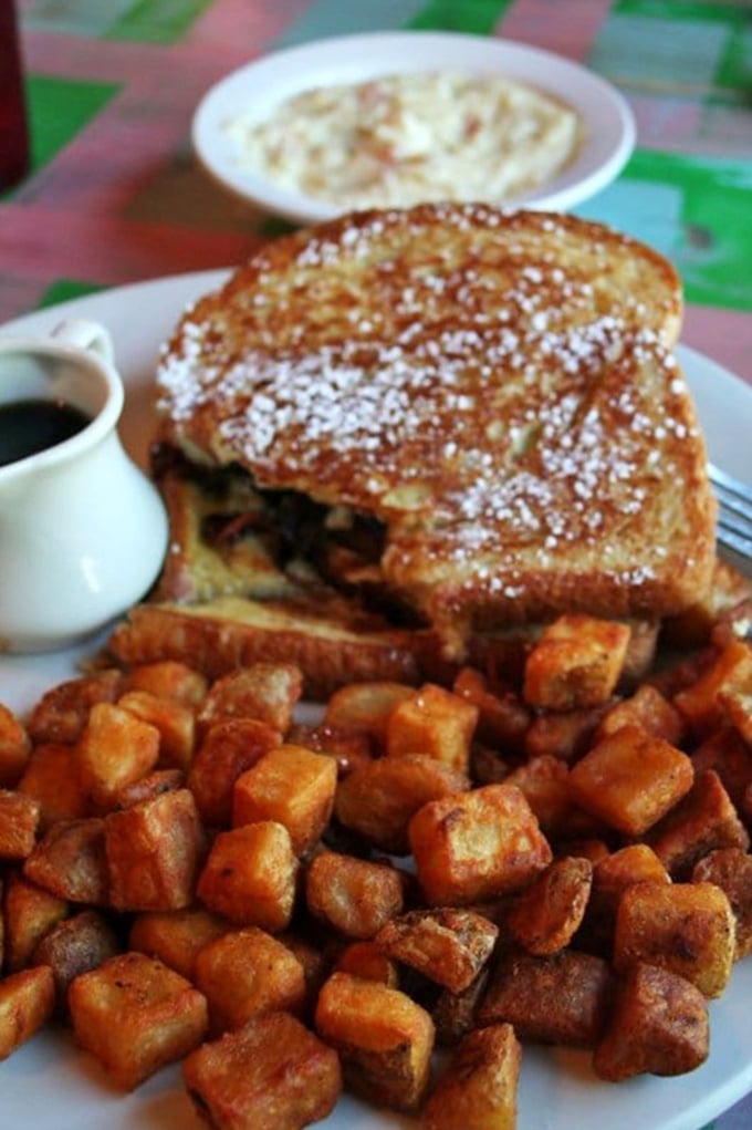 This isn't just French toast—it's a golden-crusted island surrounded by a sea of perfectly crisped home fries, a breakfast worth setting your alarm for.