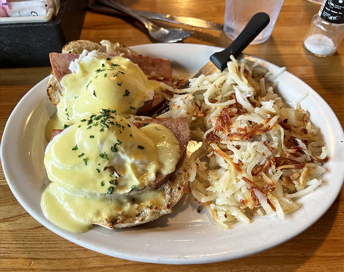 Eggs Benedict done right – perfectly poached eggs nestled on Canadian bacon, draped in hollandaise that's silky enough to make a French chef weep with joy.