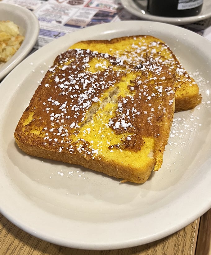 Golden French toast dusted with powdered sugar—the breakfast equivalent of finding an extra $20 in your winter coat pocket.