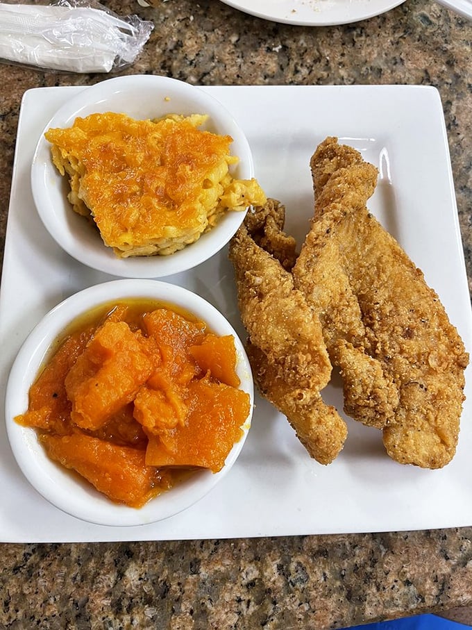 Golden-fried catfish that shatters at first bite, alongside mac and cheese that could make your grandmother question her recipe.