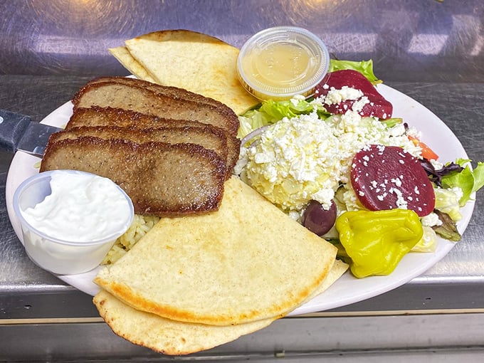 The Greek Platter arrives like a Mediterranean vacation on a plate – complete with pita bread and enough feta to make Zeus proud.
