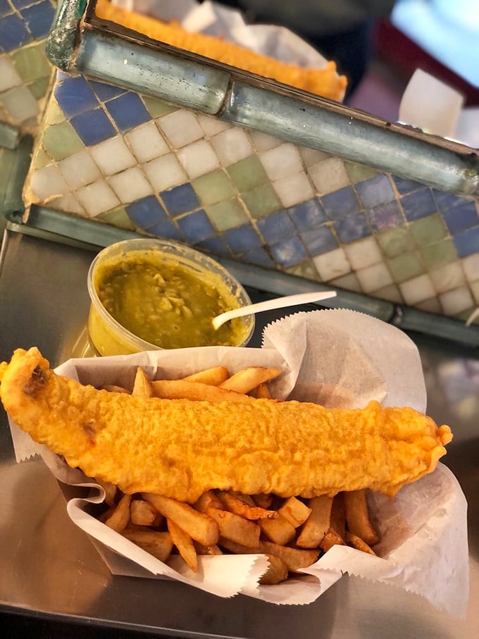 Golden-battered fish meets its perfect companions. This haddock rests majestically atop proper chips with a side of mushy peas—the holy trinity of British comfort food.