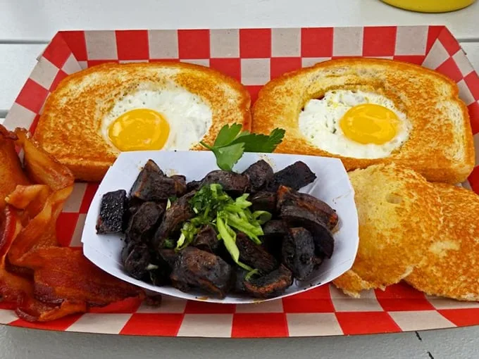 Eggs-in-toast meets home fries that look like they've been kissed by fire gods. This plate doesn't just feed you—it hugs your soul.