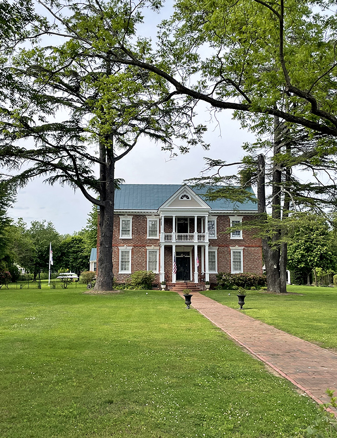 The Lansdowne stands proudly as Urbanna's architectural crown jewel, a Georgian brick beauty that's witnessed nearly three centuries of American history from its grassy perch.