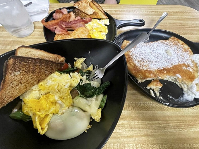Breakfast alchemy at its finest: golden eggs, crispy bacon, and home fries that could make a potato farmer weep with pride.