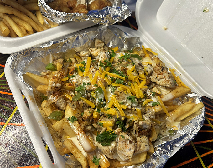 Loaded fries that require a game plan. This cheesy, herb-sprinkled masterpiece demands strategic eating—do you save the gooiest parts for last?