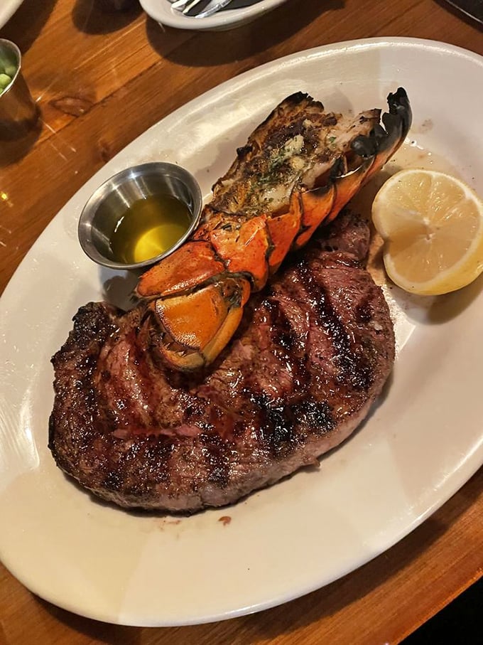 A surf and turf symphony—perfectly charred ribeye meets its delicious lobster companion. This isn't dinner; it's a celebration on a plate.