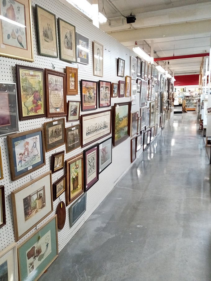 A gallery wall that would make any decorator swoon – dozens of framed prints and artwork create a time-traveling tapestry of visual history.
