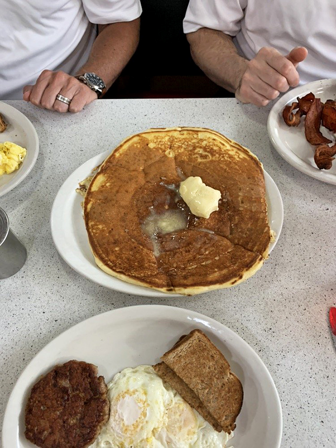 The legendary pancake in its natural habitat – golden-brown, butter-melting perfection that makes you question why you'd eat pancakes anywhere else.
