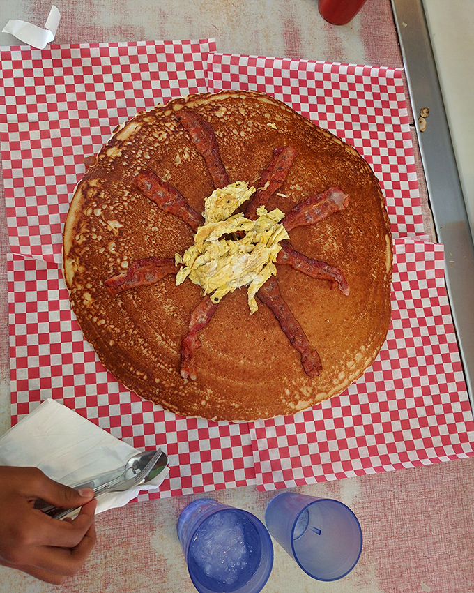 Behold the pancake sunburst! Golden-brown perfection with bacon rays radiating from a buttery center – breakfast architecture at its finest.