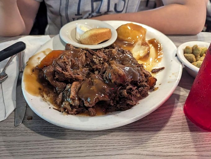 This isn't just pot roast—it's a master class in patience, where tough cuts surrender into fork-tender submission under a blanket of soul-satisfying gravy.